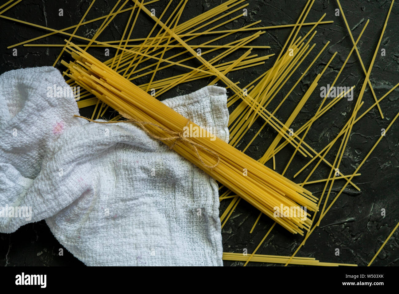 bunch of raw spaghetti top view, flat lay on dark surface Stock Photo ...