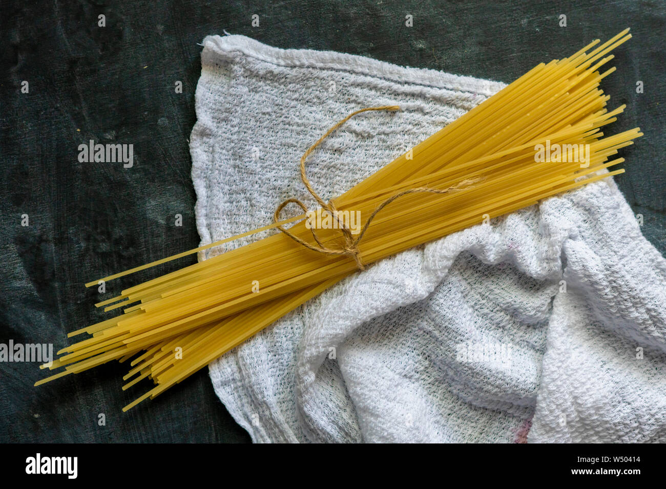 bunch of raw spaghetti top view, flat lay on dark surface Stock Photo ...