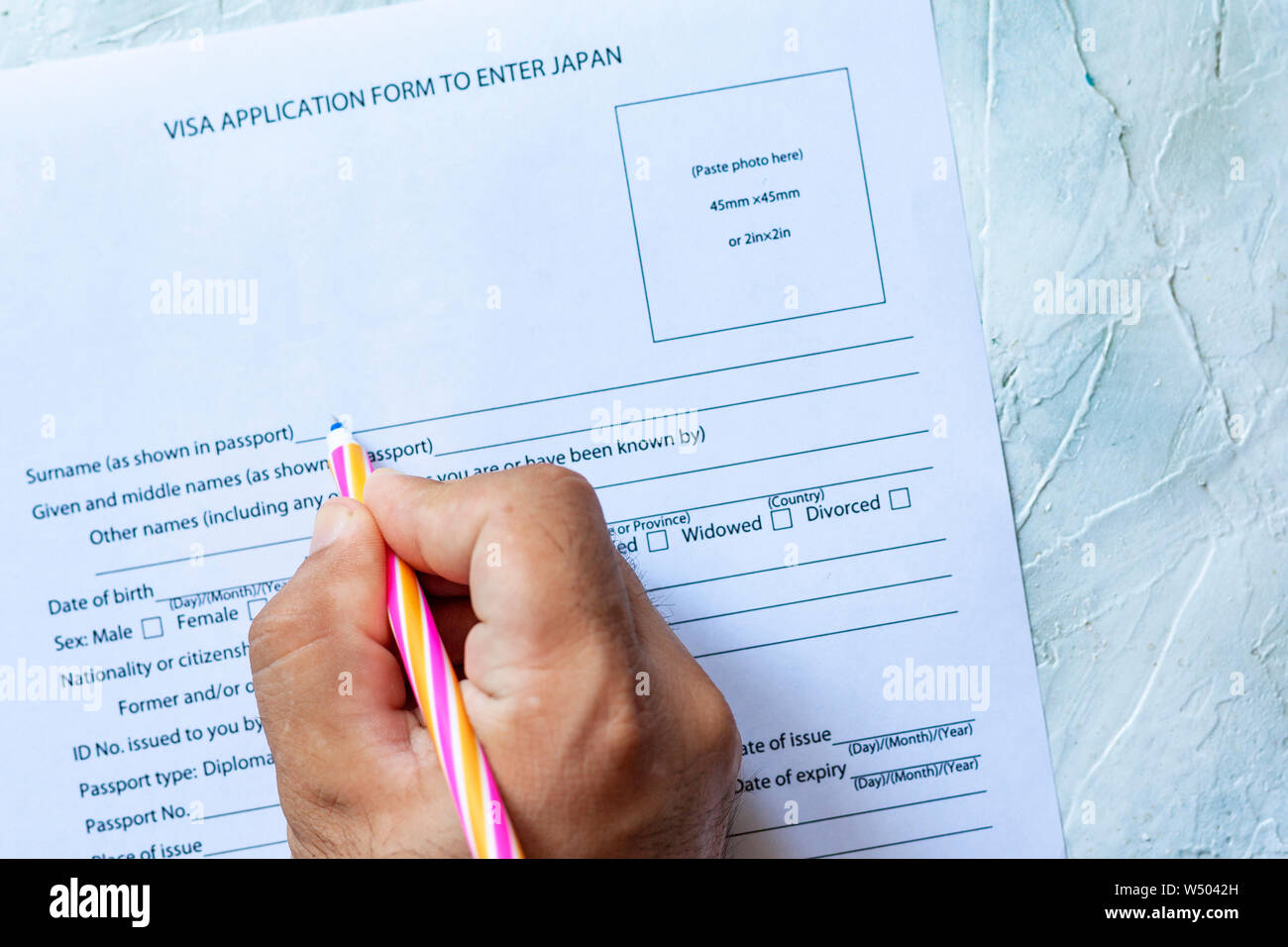 The person filling the Visa application form to enter Japan Stock Photo ...