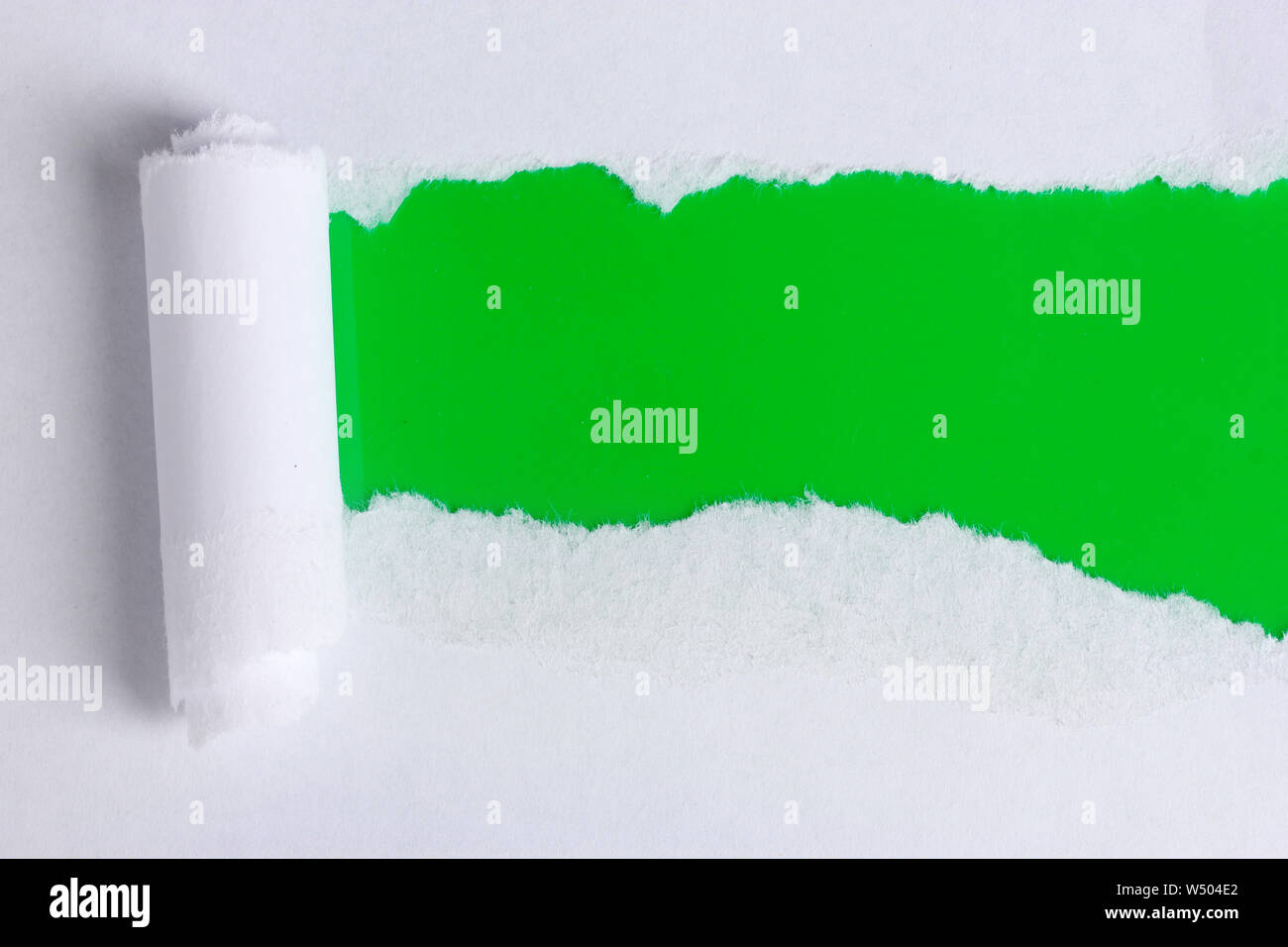 Torn paper with green background Stock Photo - Alamy