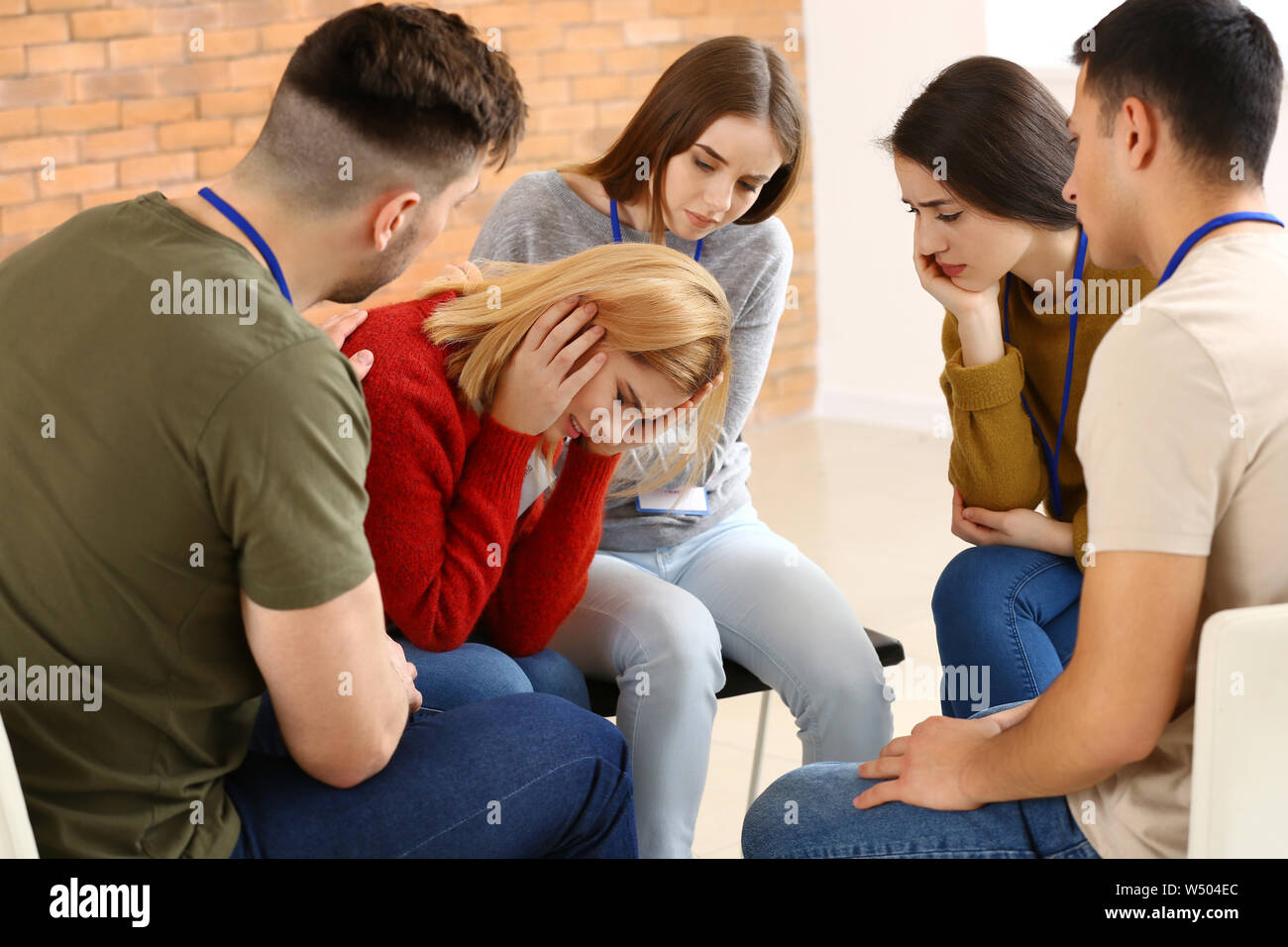 People calming woman at group therapy session Stock Photo - Alamy