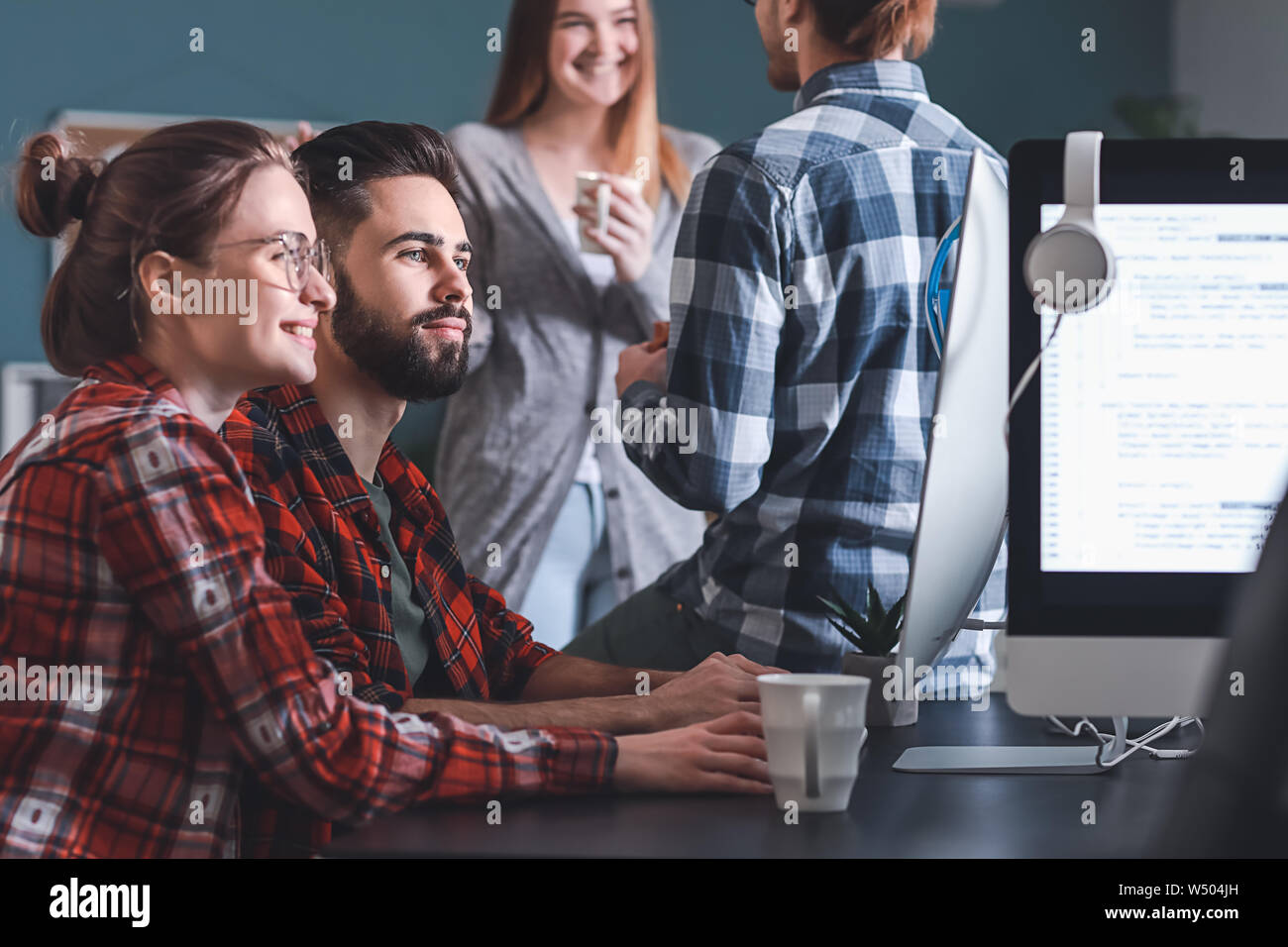 Team of programmers working in office Stock Photo - Alamy