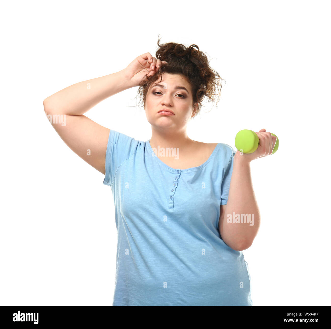 Tired overweight woman with dumbbell on white background Stock Photo ...