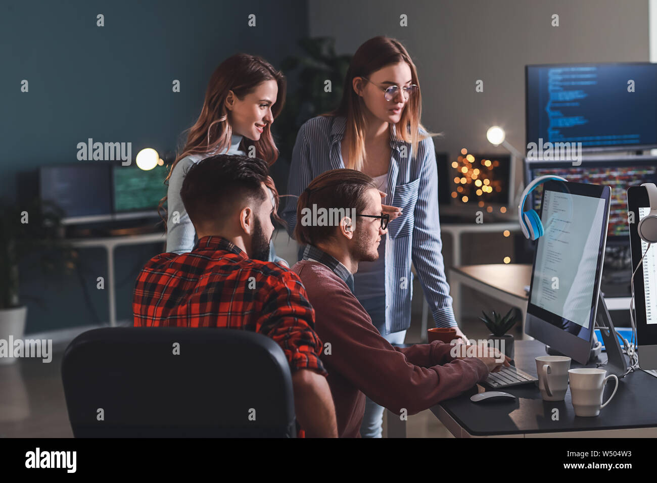 Team of programmers working in office Stock Photo - Alamy