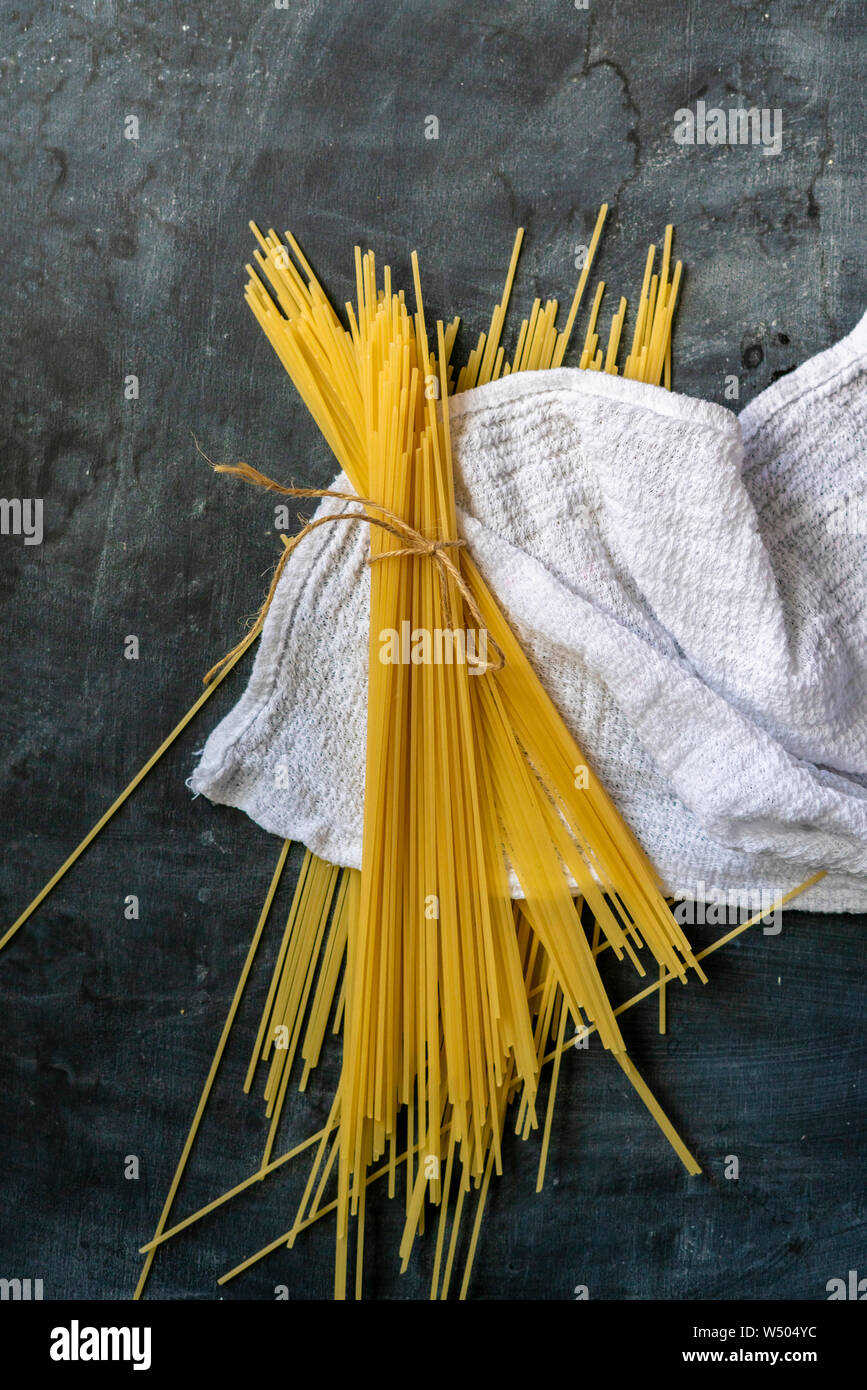 bunch of raw spaghetti top view, flat lay on dark surface Stock Photo ...