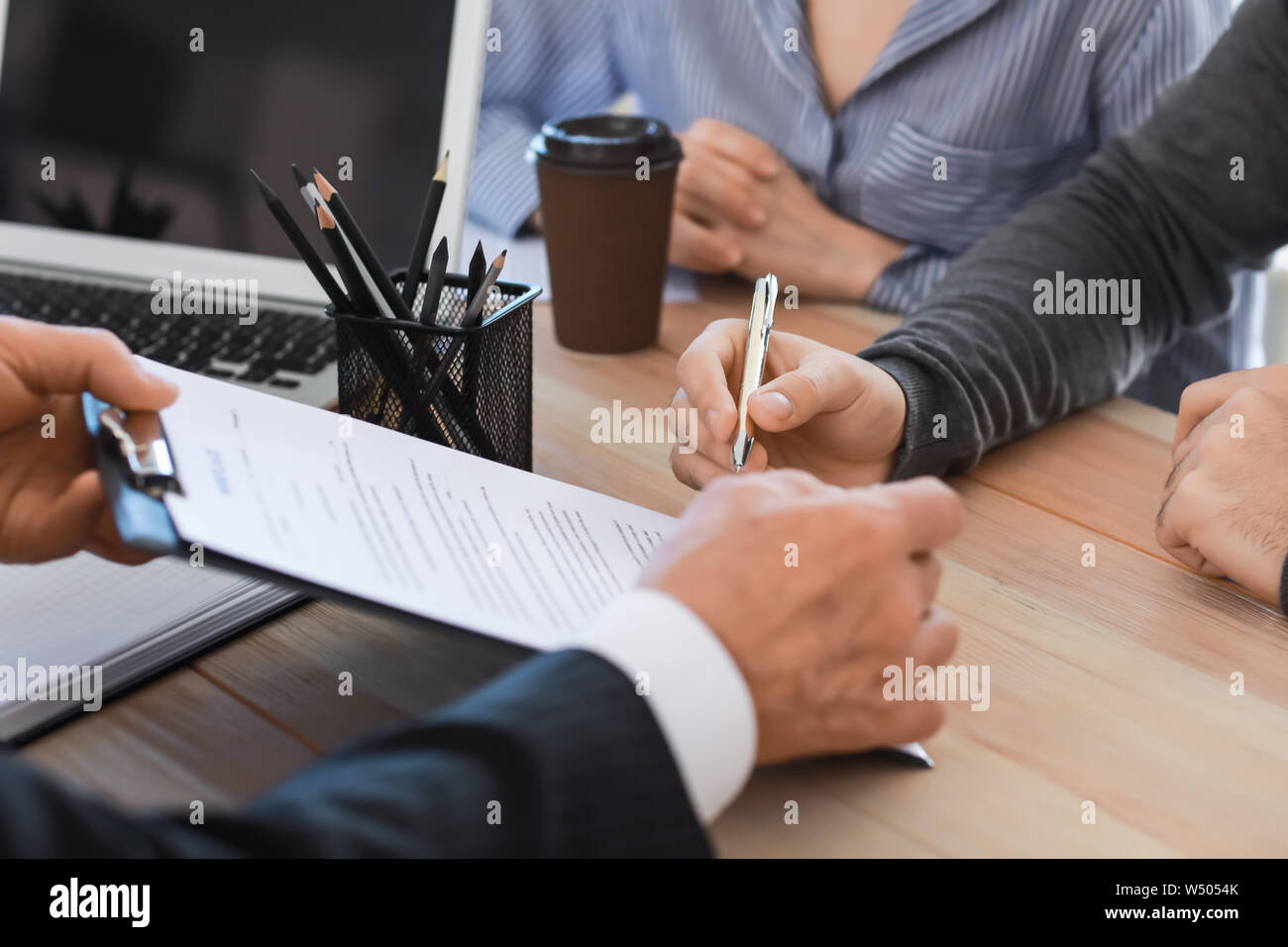 Couple signing documents at notary public office Stock Photo - Alamy