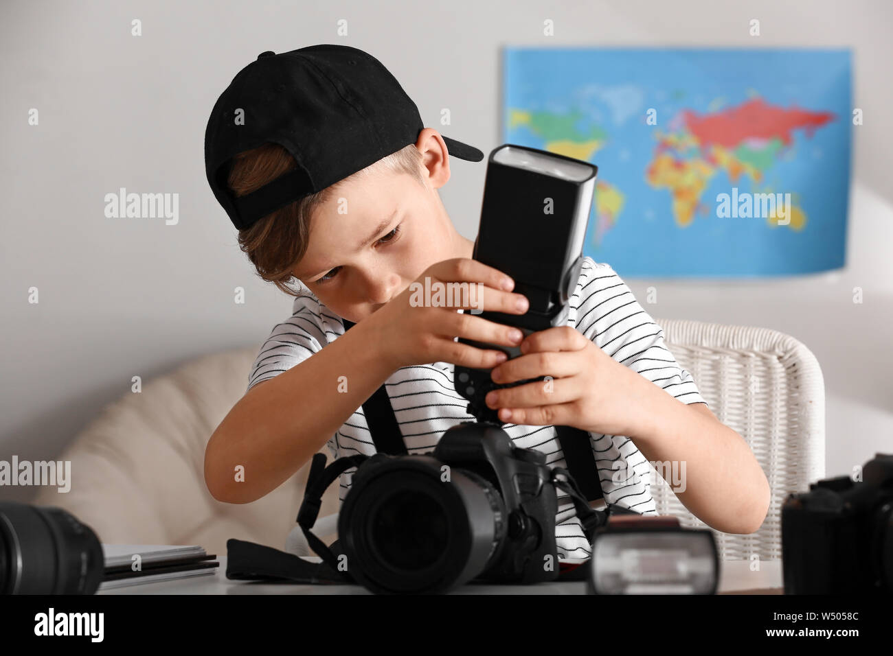 Cute little photographer with professional camera at home Stock Photo ...