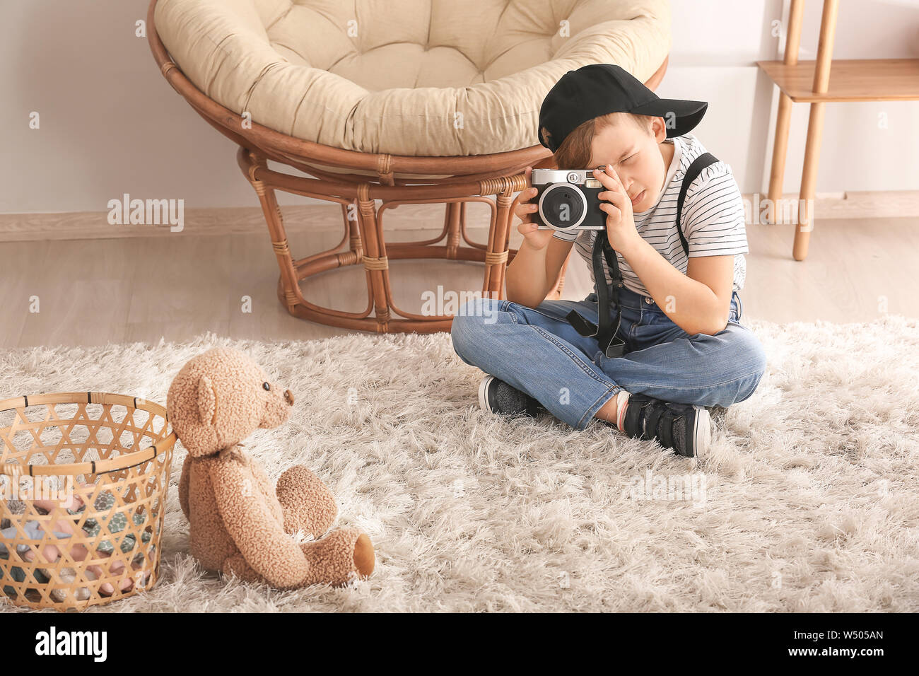 Cute little photographer with professional camera at home Stock Photo ...