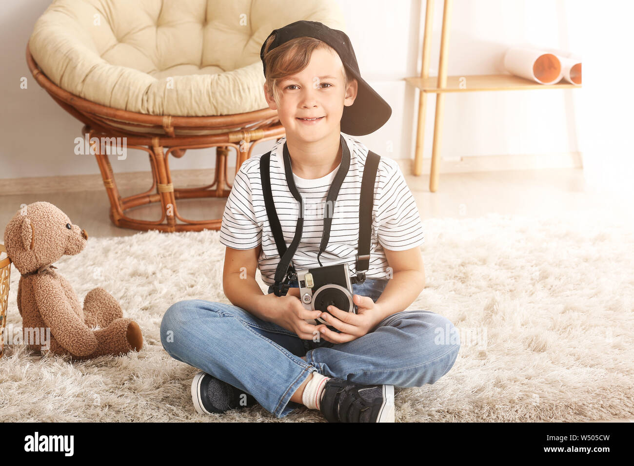 Cute little photographer with professional camera at home Stock Photo ...