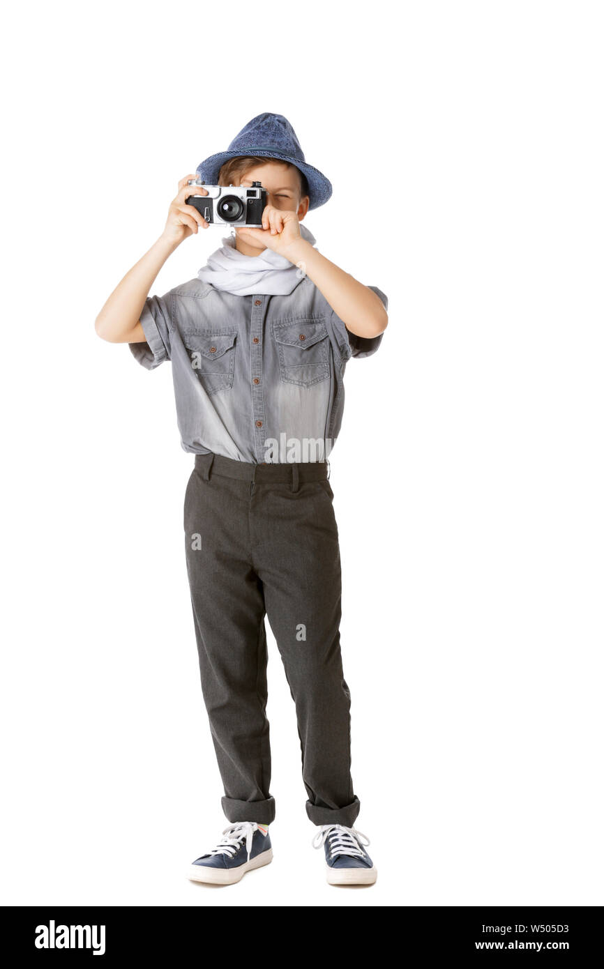 Cute little photographer with professional camera on white background ...