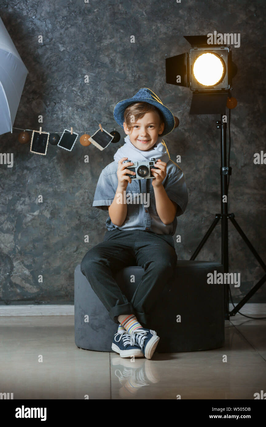 Cute little photographer with camera in professional studio Stock Photo ...