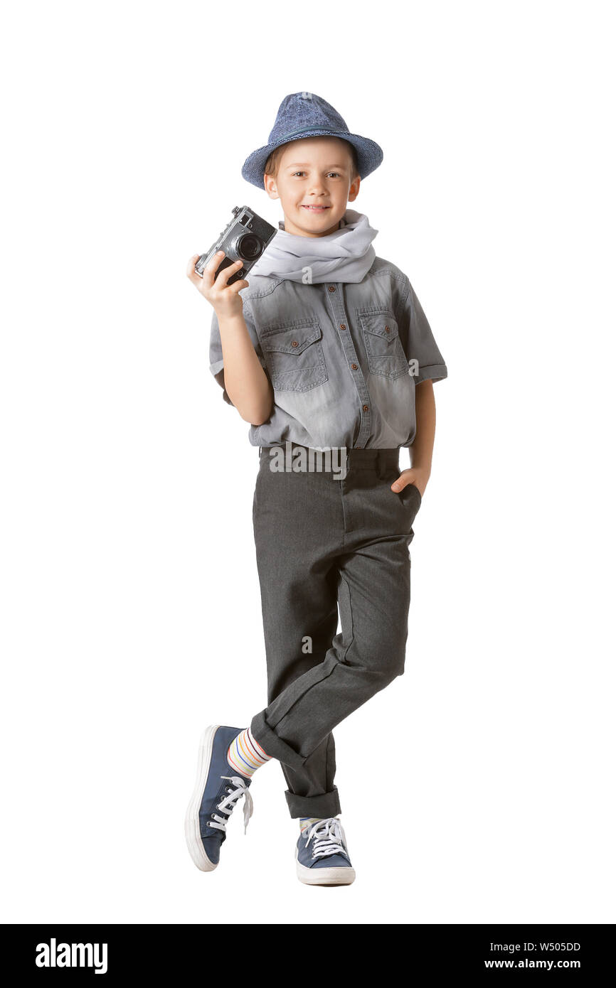 Cute little photographer with professional camera on white background ...