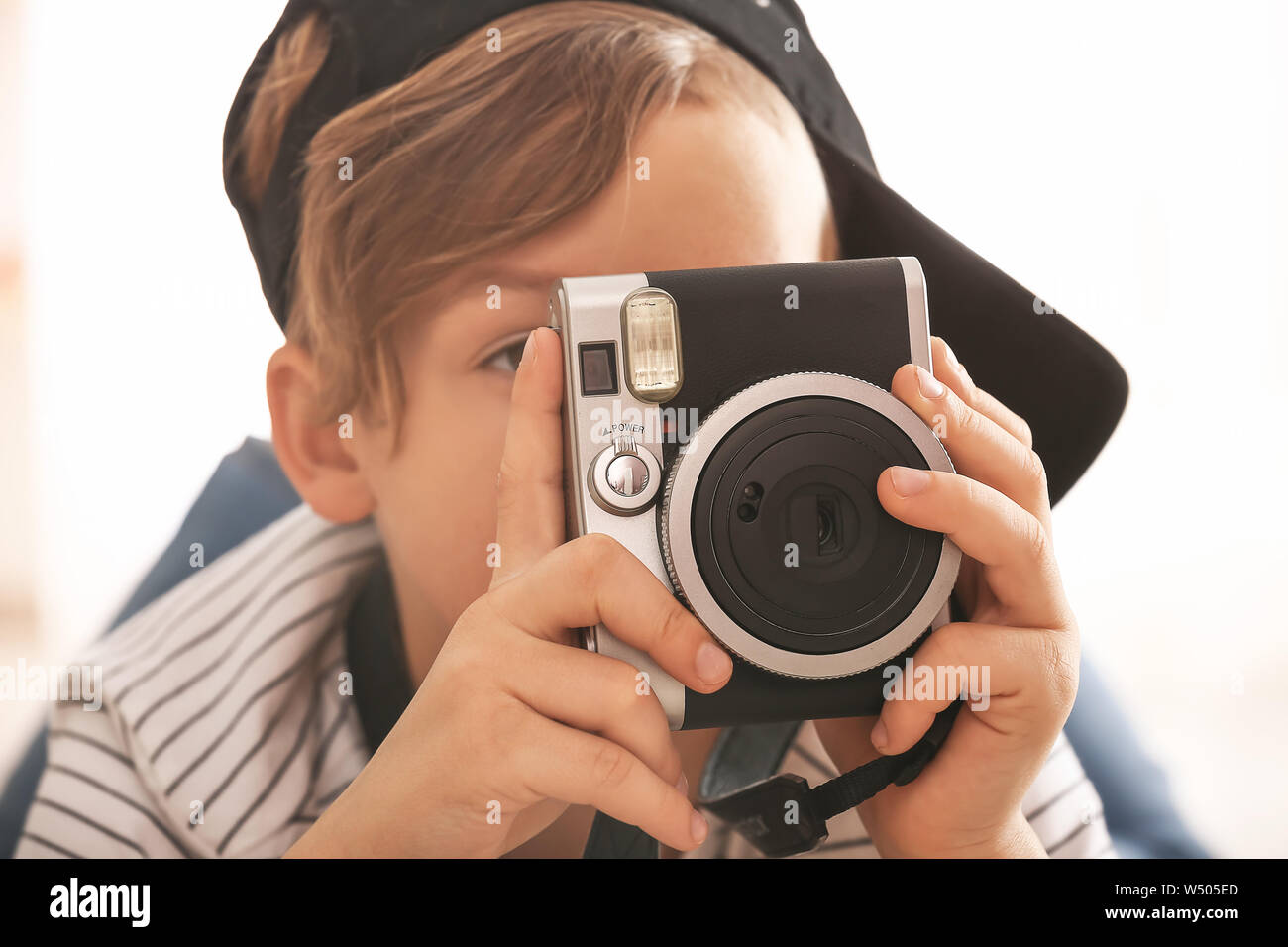 Cute little photographer with professional camera Stock Photo - Alamy