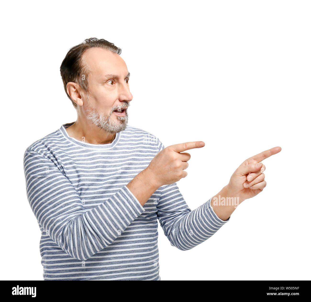 Portrait of emotional mature man pointing at something on white ...