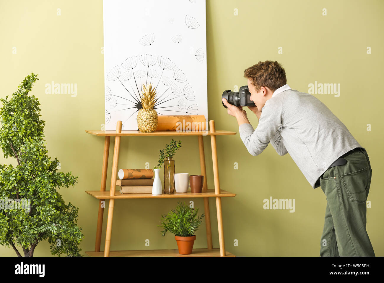 Teenage boy with photo camera at home Stock Photo - Alamy
