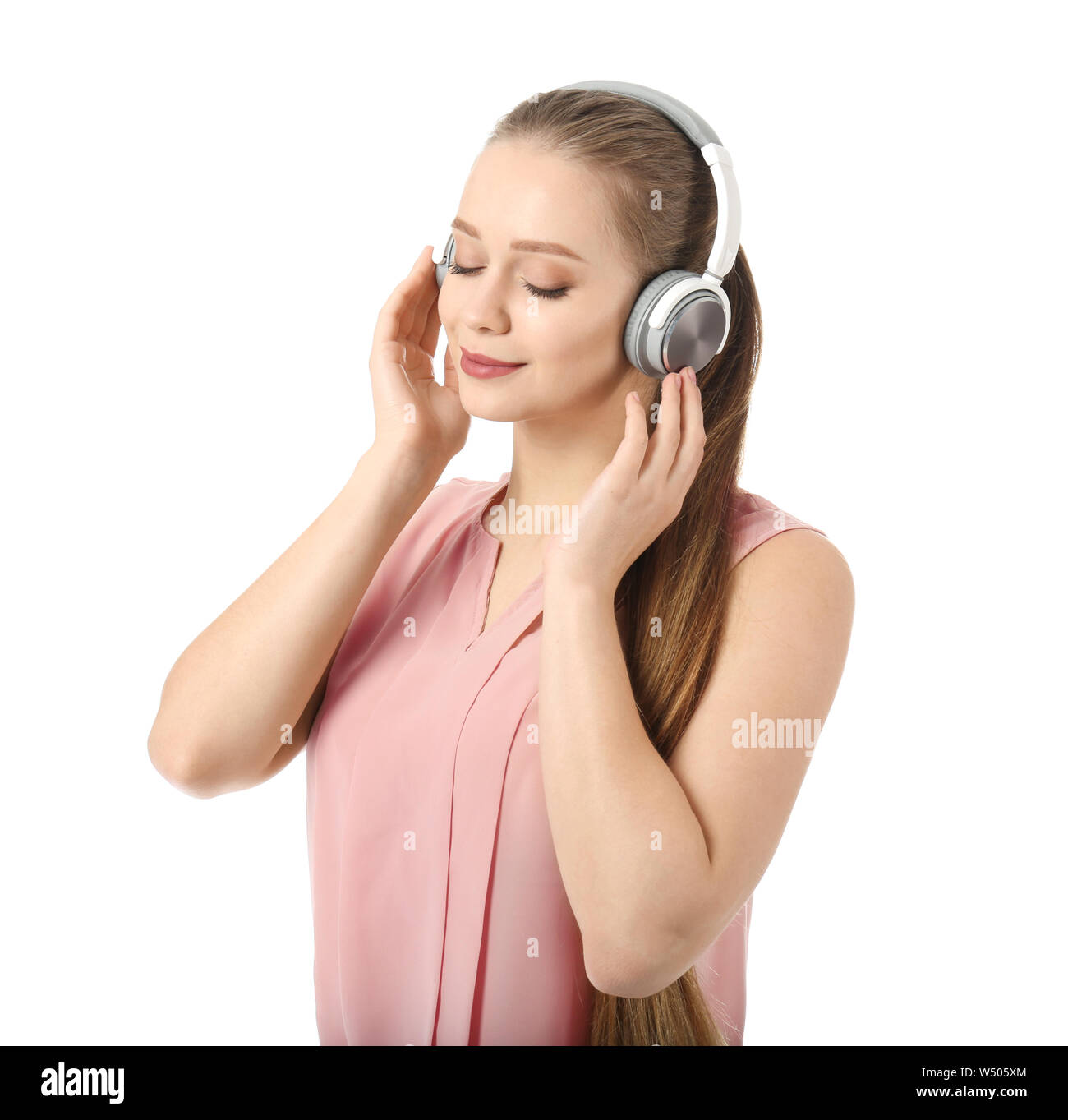 Beautiful young woman listening to music on white background Stock ...