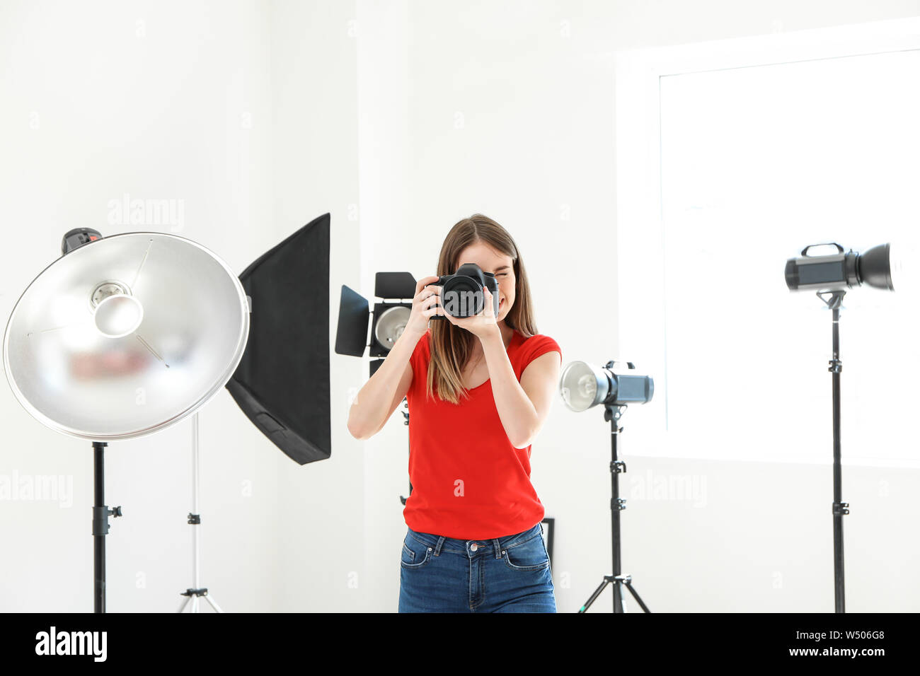 Young female photographer in studio Stock Photo - Alamy