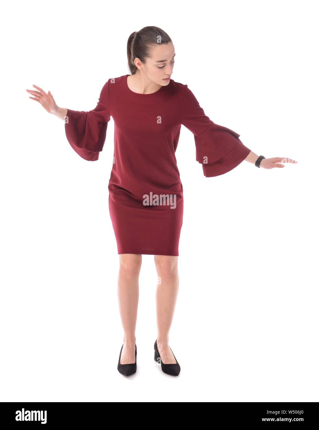 Balancing young woman on white background Stock Photo - Alamy