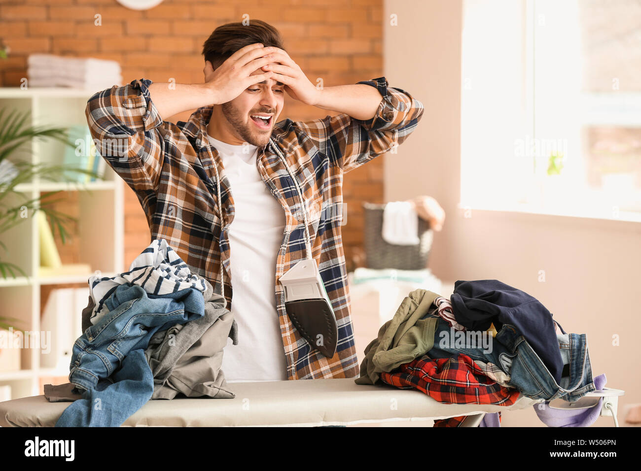 Man ironing panic hi-res stock photography and images - Alamy