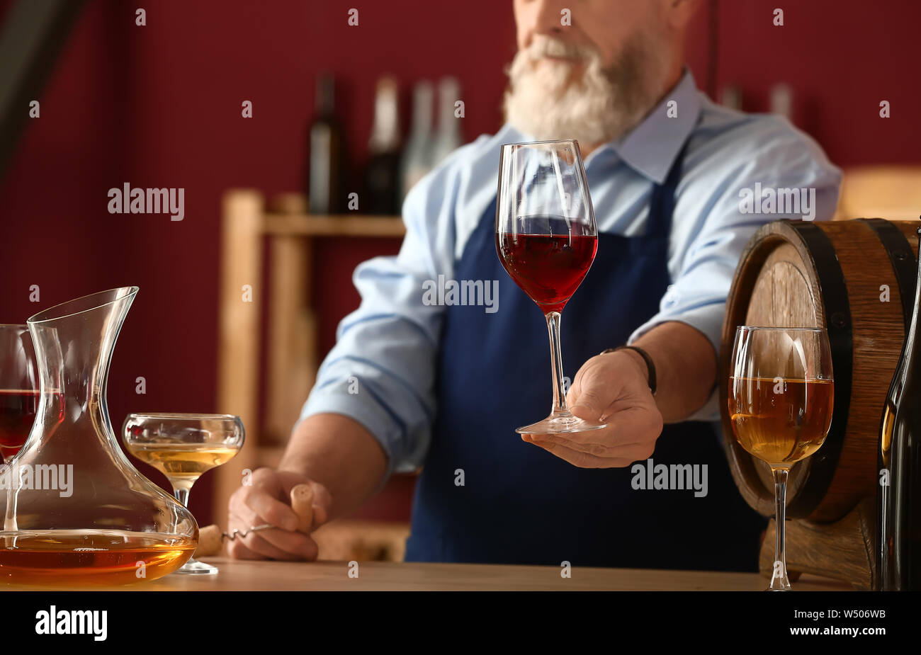 Mature sommelier working in wine cellar Stock Photo - Alamy