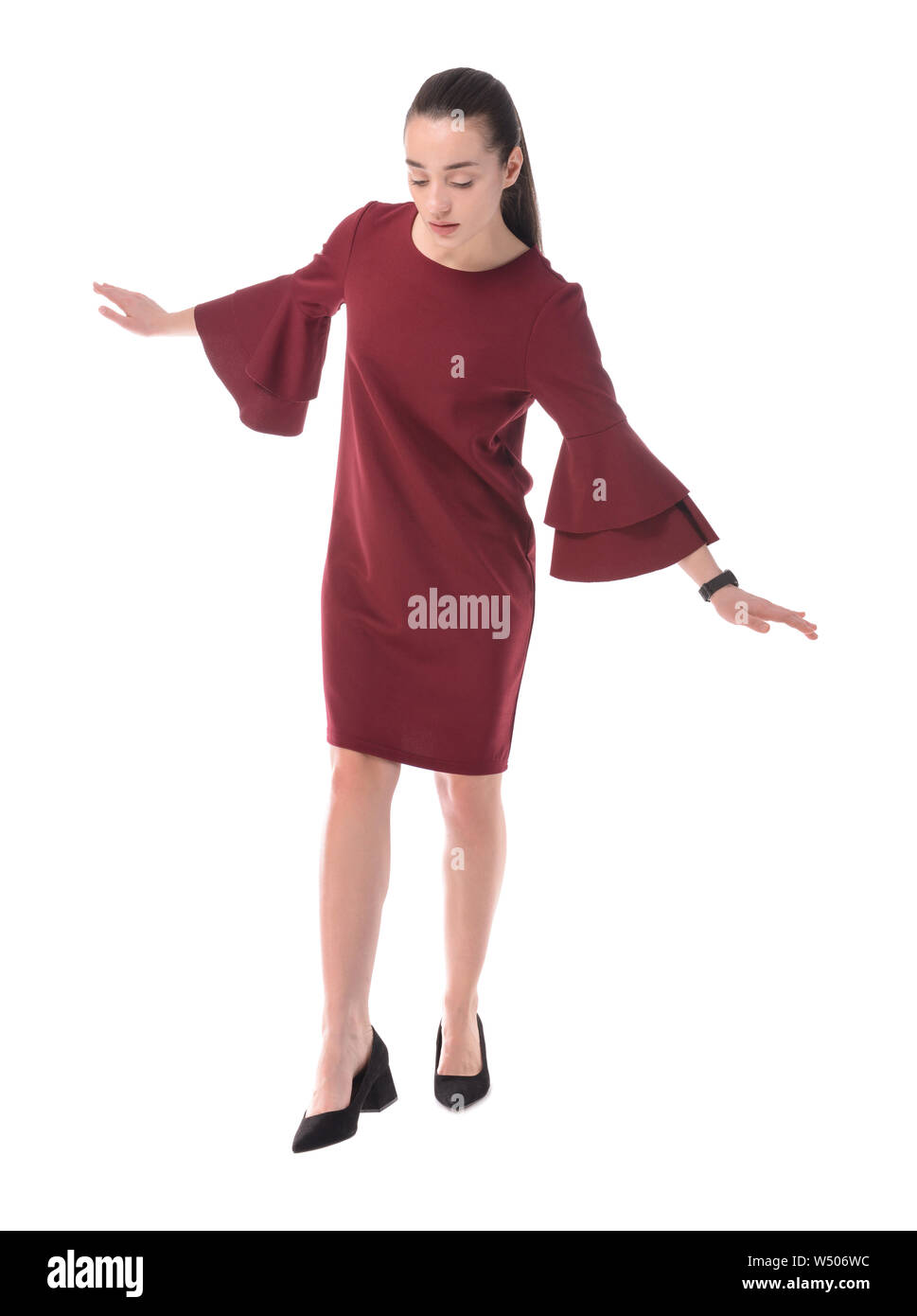 Balancing young woman on white background Stock Photo - Alamy