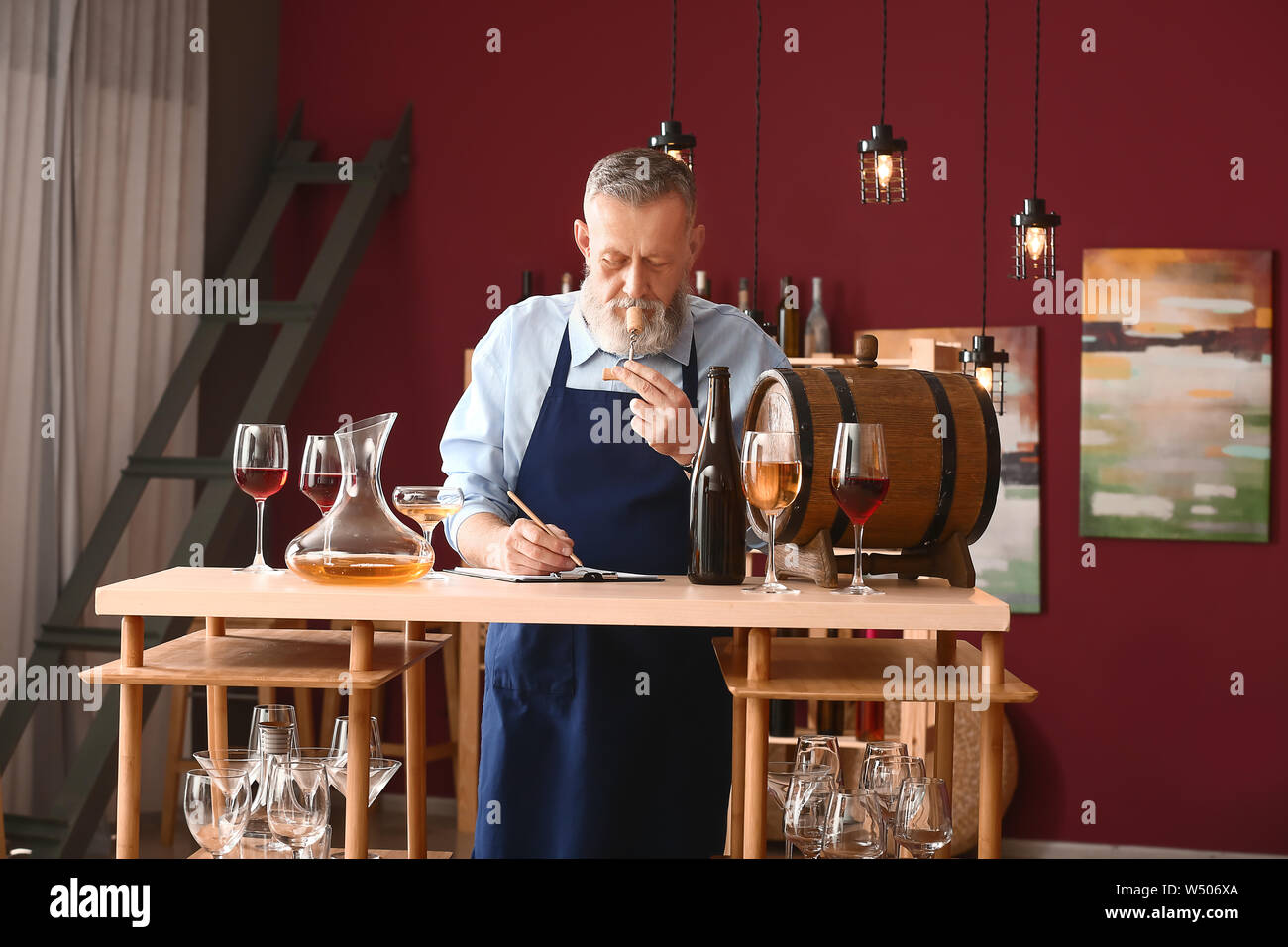 Mature sommelier working in wine cellar Stock Photo - Alamy
