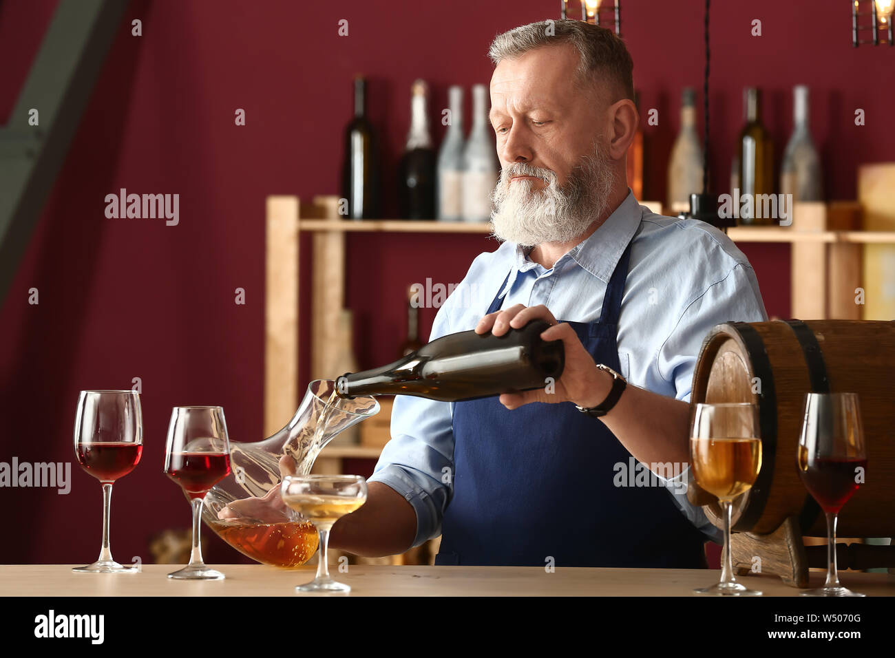 Mature sommelier working in wine cellar Stock Photo - Alamy