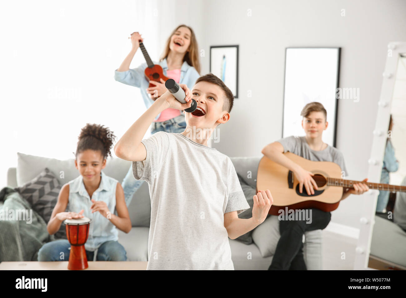 Teenage playing instrument band home hi-res stock photography and ...