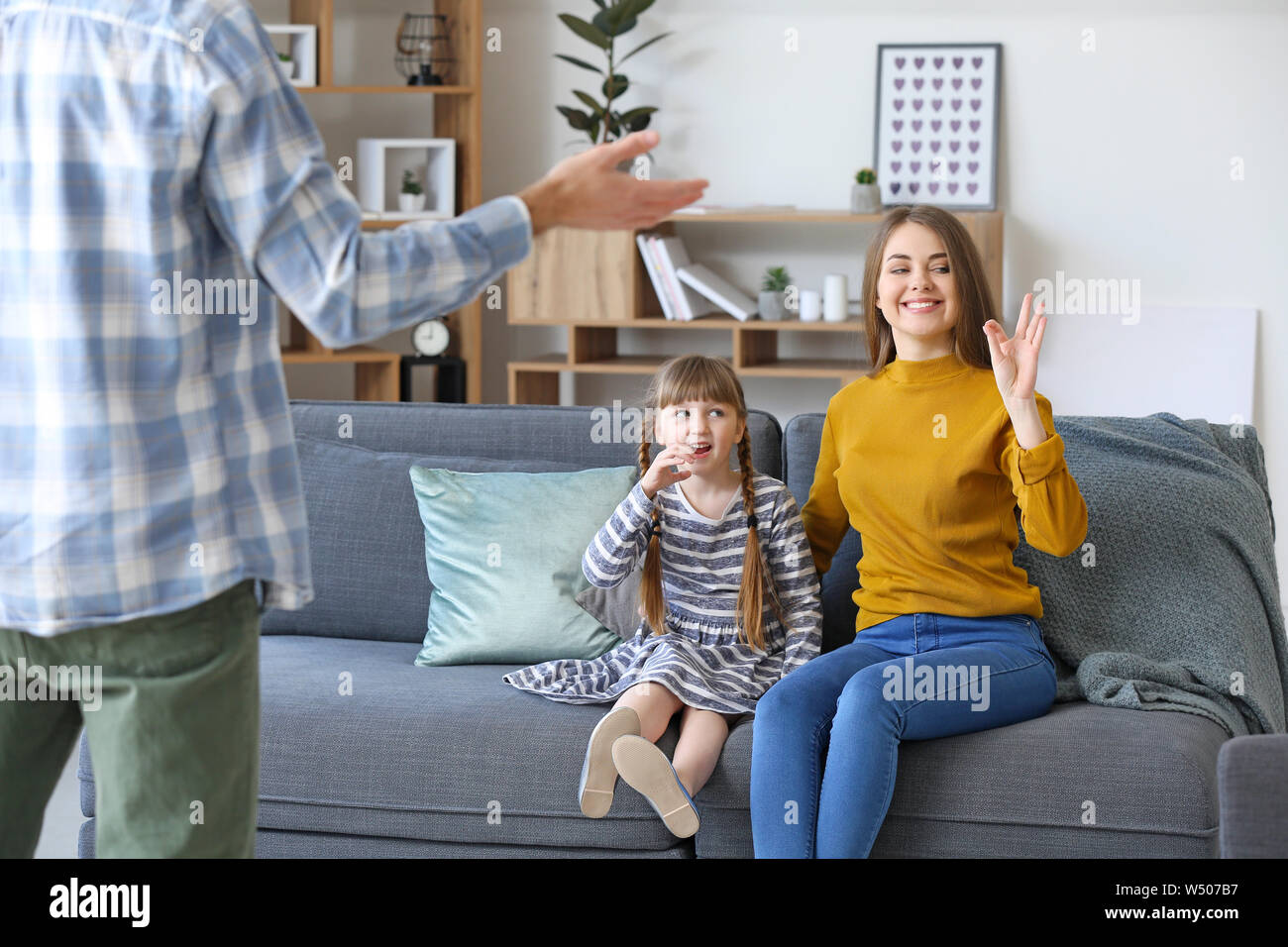 Deaf mute family using sign language at home Stock Photo - Alamy