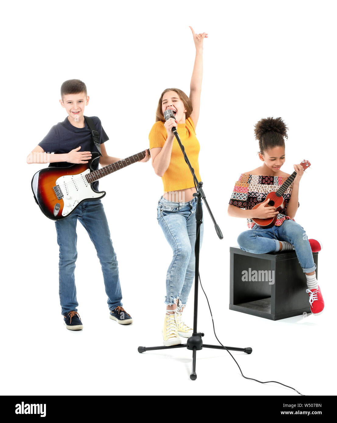 Teenage musicians playing against white background Stock Photo - Alamy