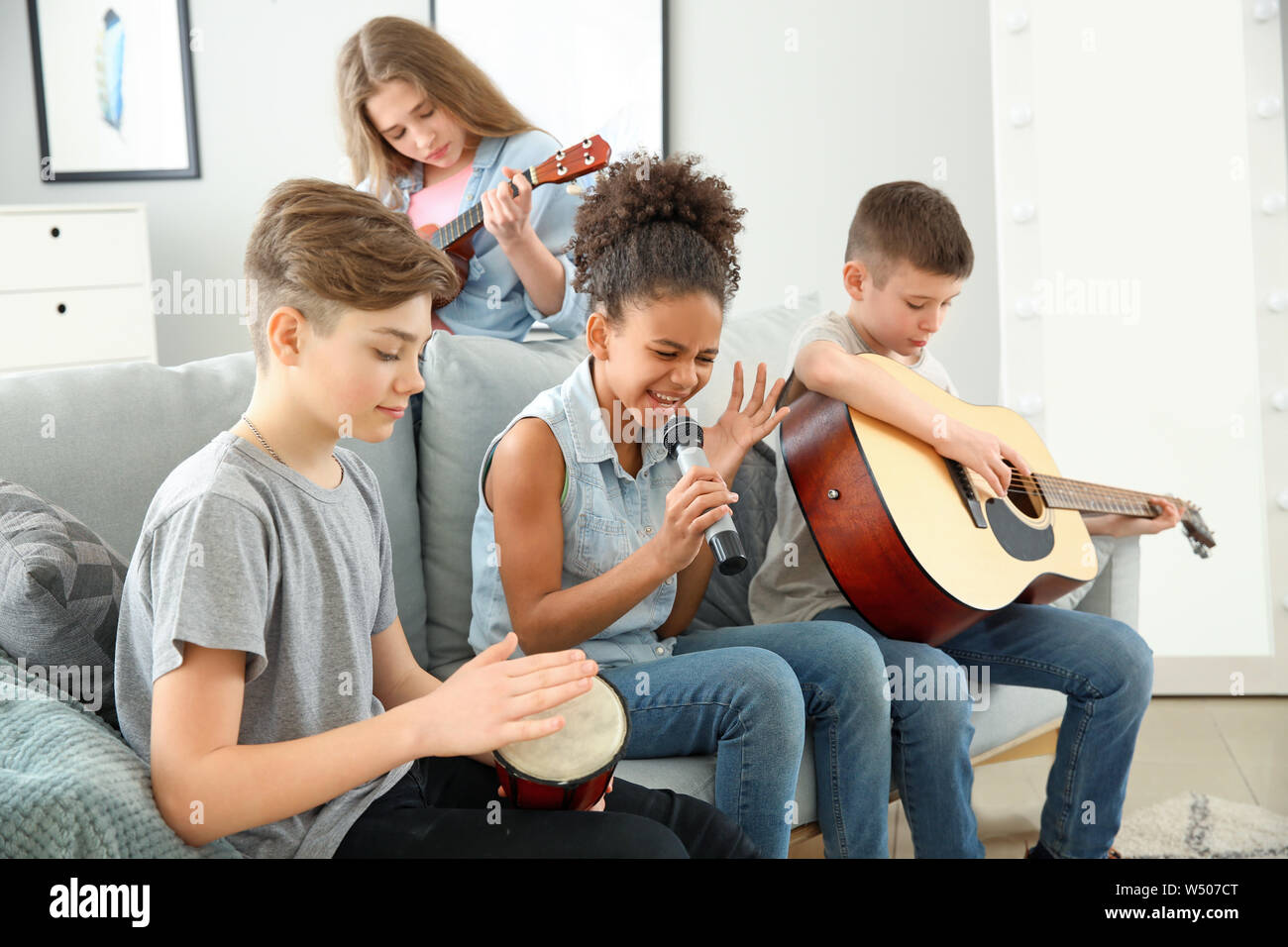 Teenage playing instrument band home hi-res stock photography and ...