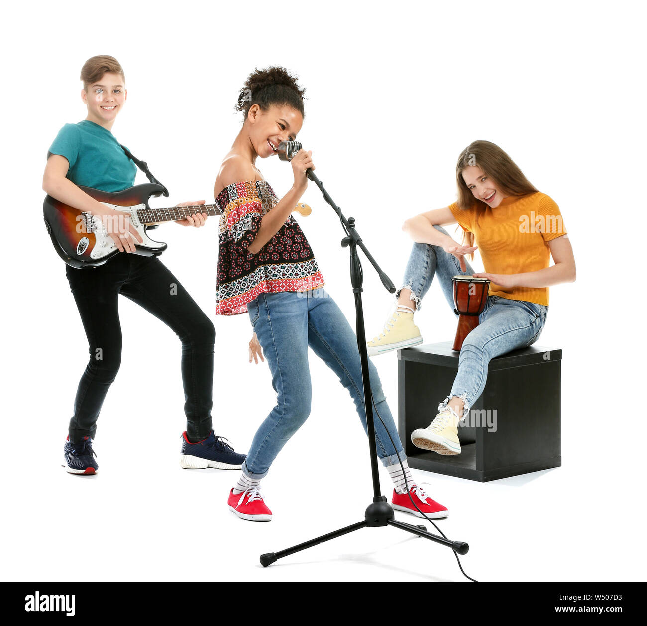 Teenage musicians playing against white background Stock Photo - Alamy