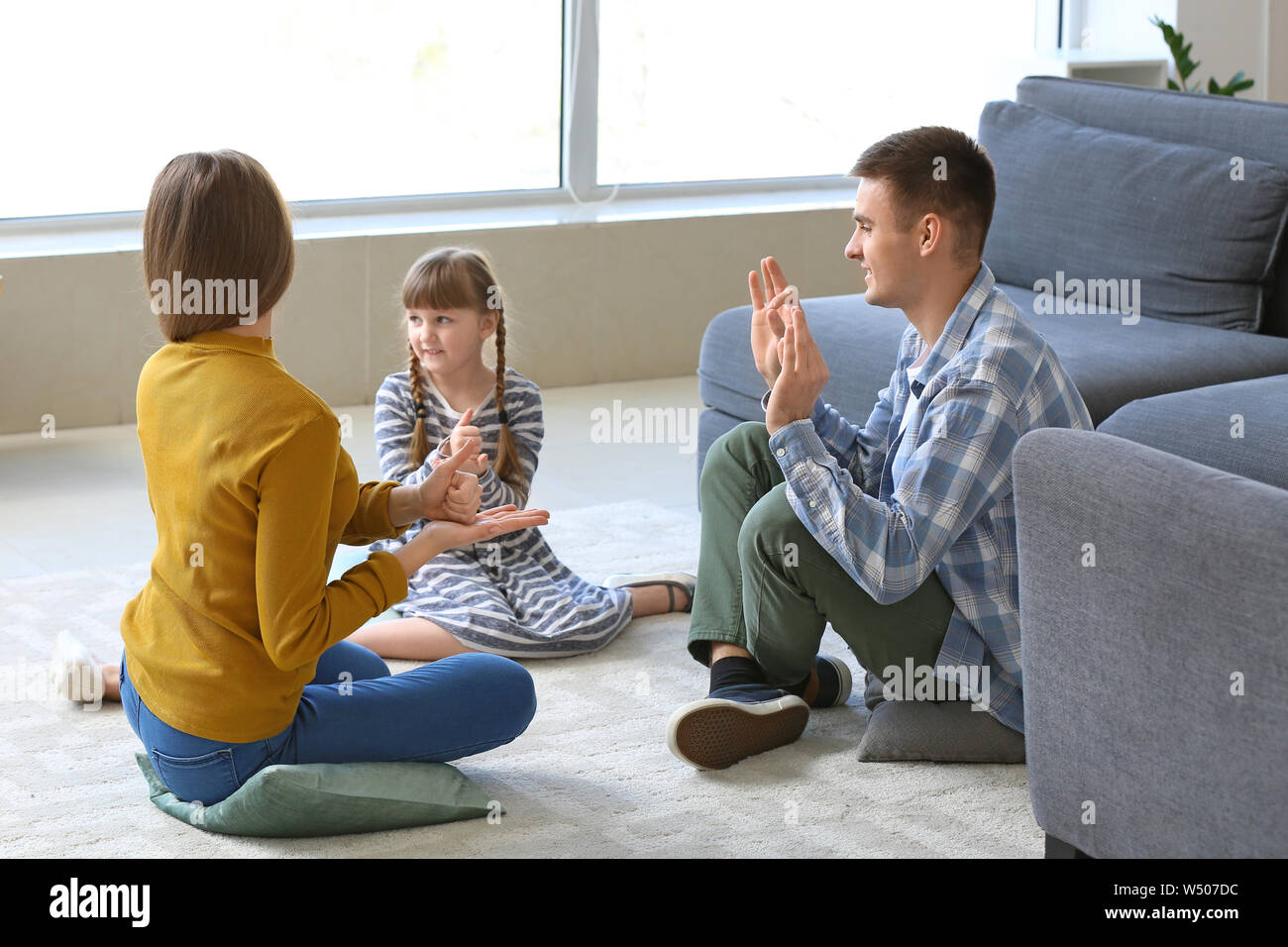 Deaf mute family using sign language at home Stock Photo - Alamy