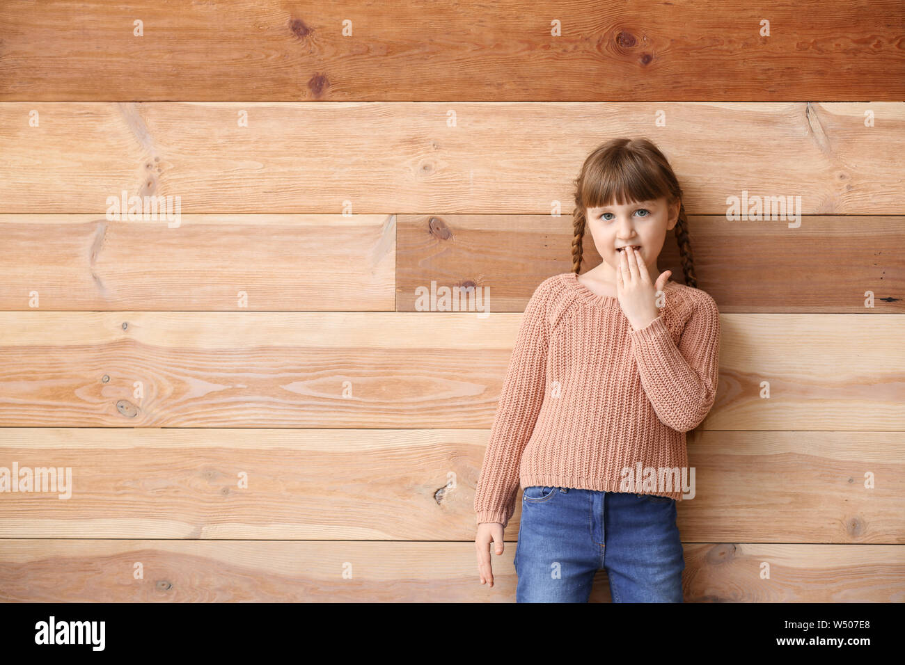 Cute deaf mute girl using sign language on wooden background Stock ...