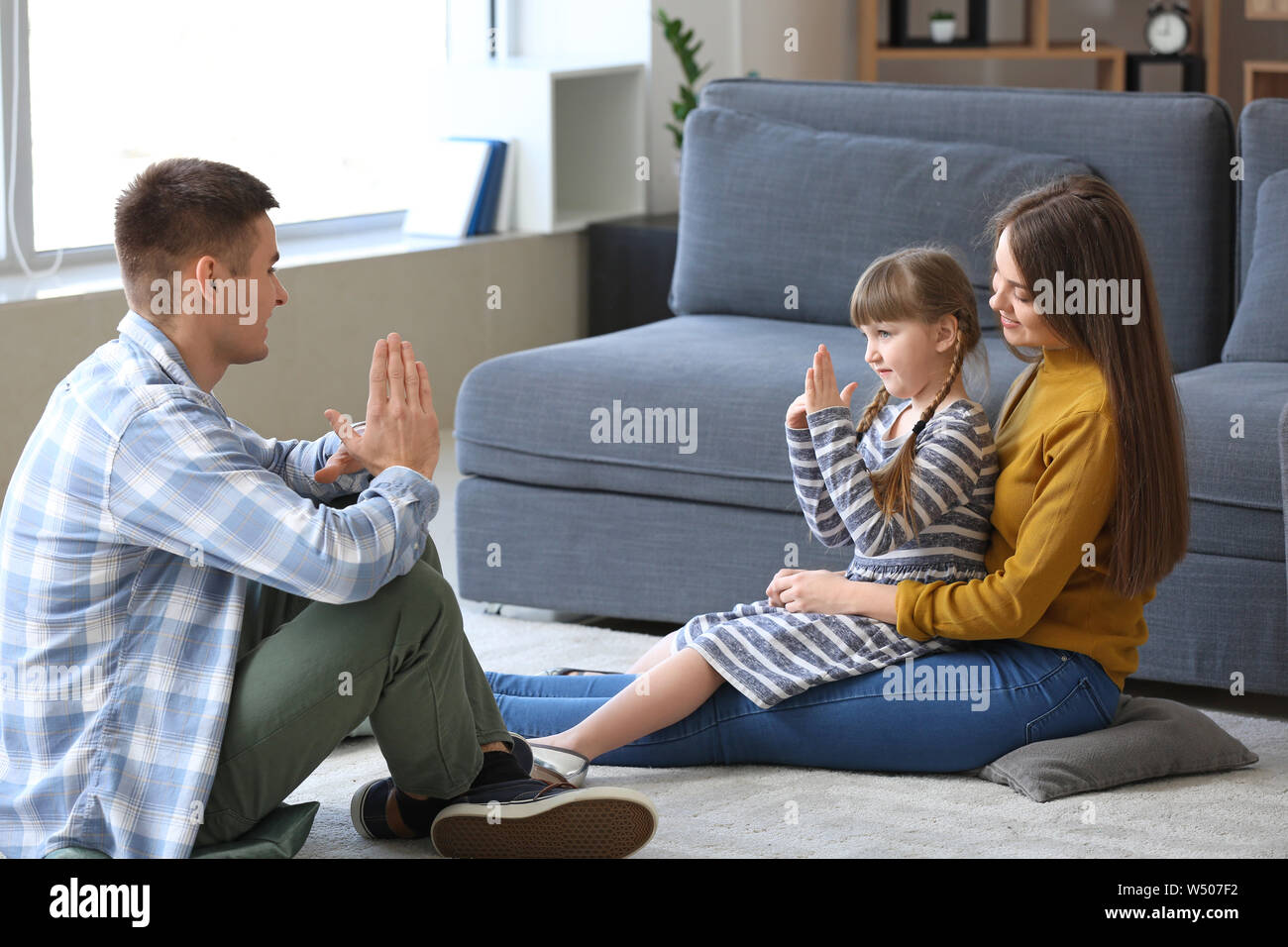 Deaf mute family using sign language at home Stock Photo - Alamy