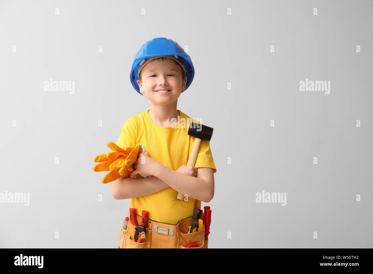 Cute little worker on white background Stock Photo - Alamy