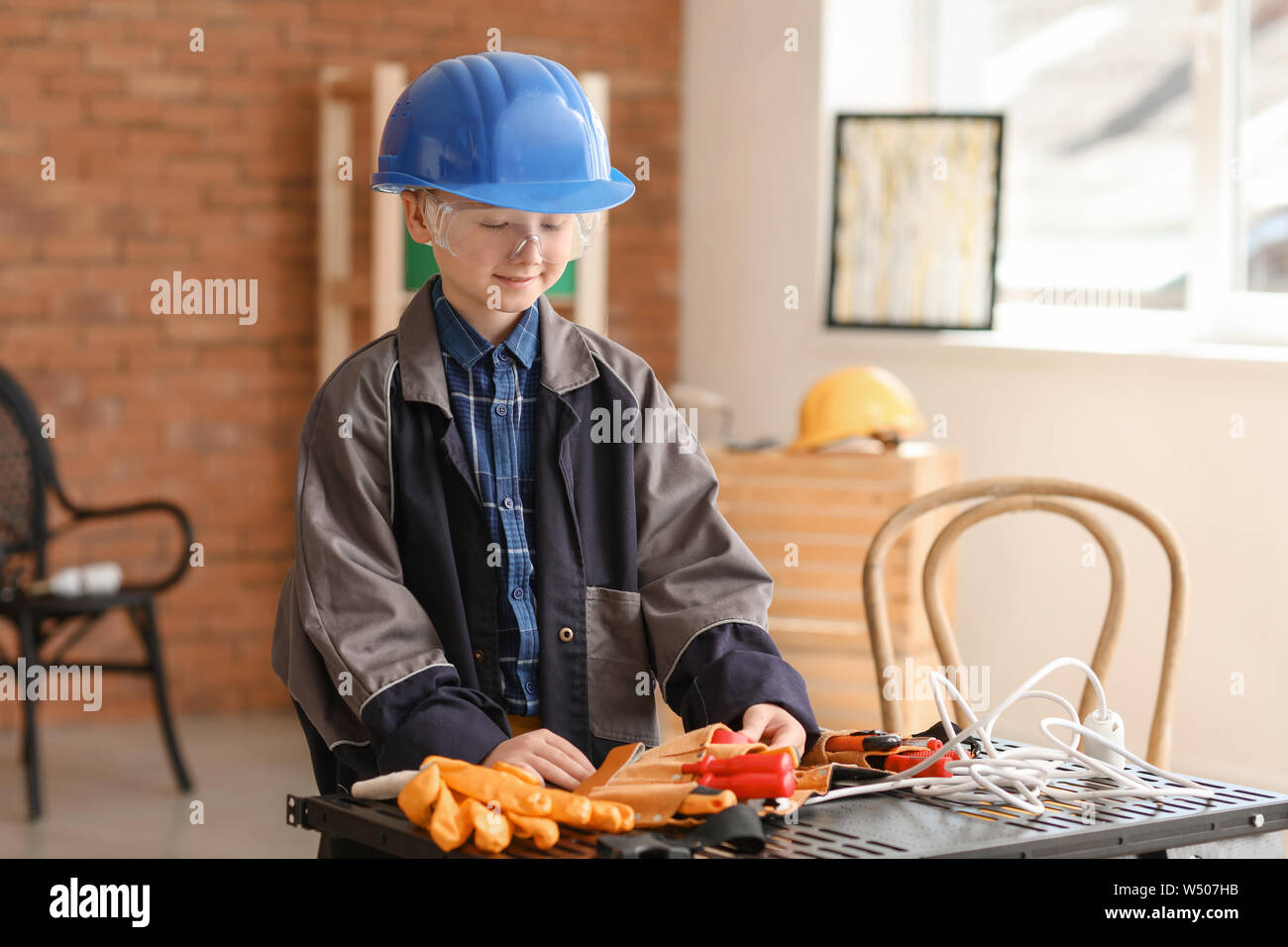 Cute little worker indoors Stock Photo - Alamy
