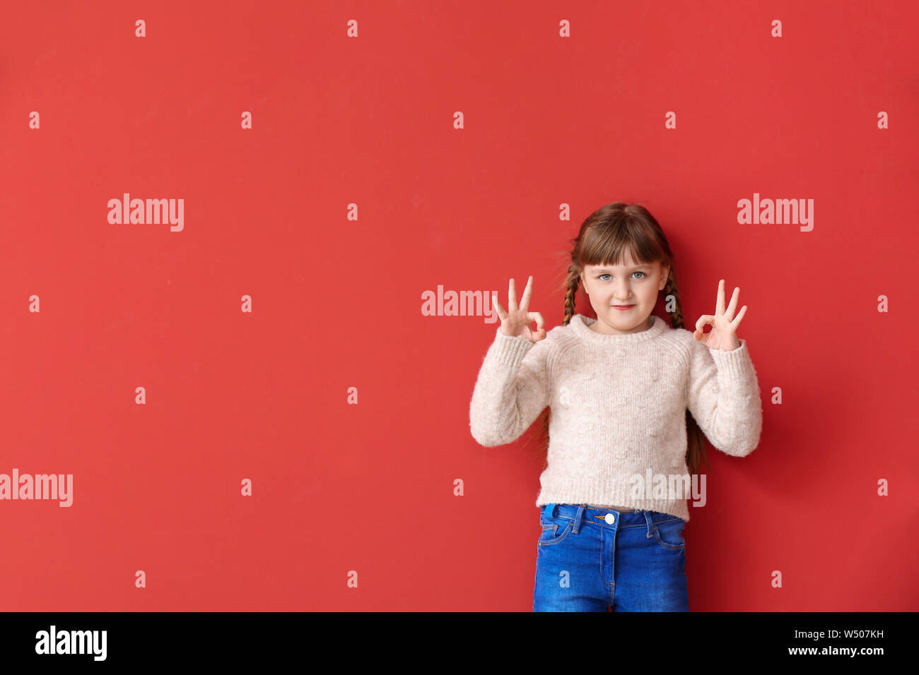 Cute deaf mute girl using sign language on color background Stock Photo ...