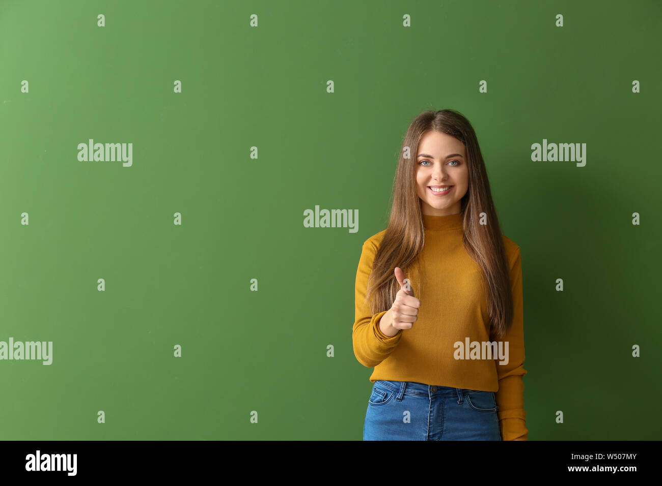 Young deaf mute woman using sign language on color background Stock ...