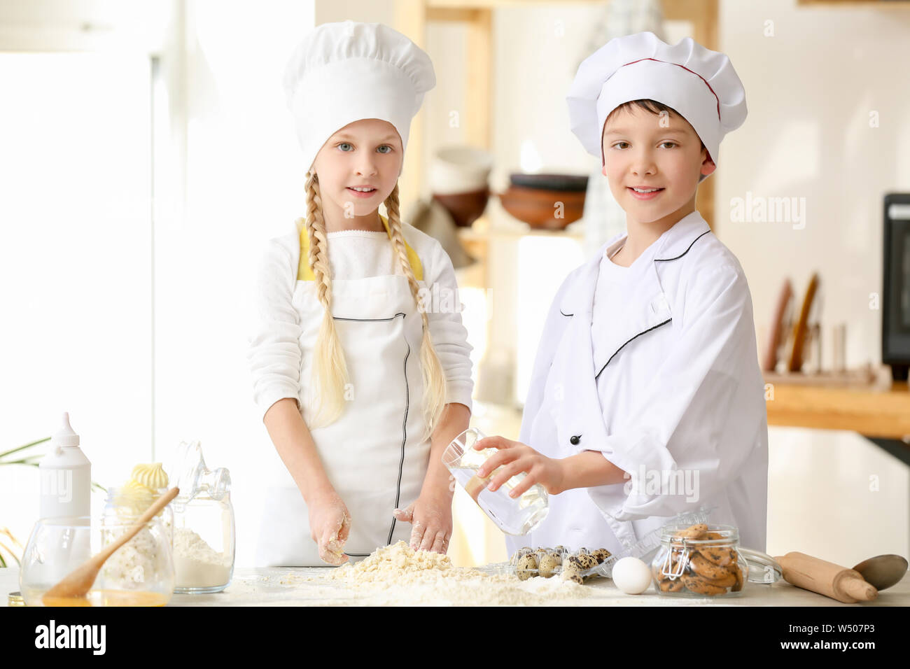Cute little chefs cooking in kitchen Stock Photo - Alamy