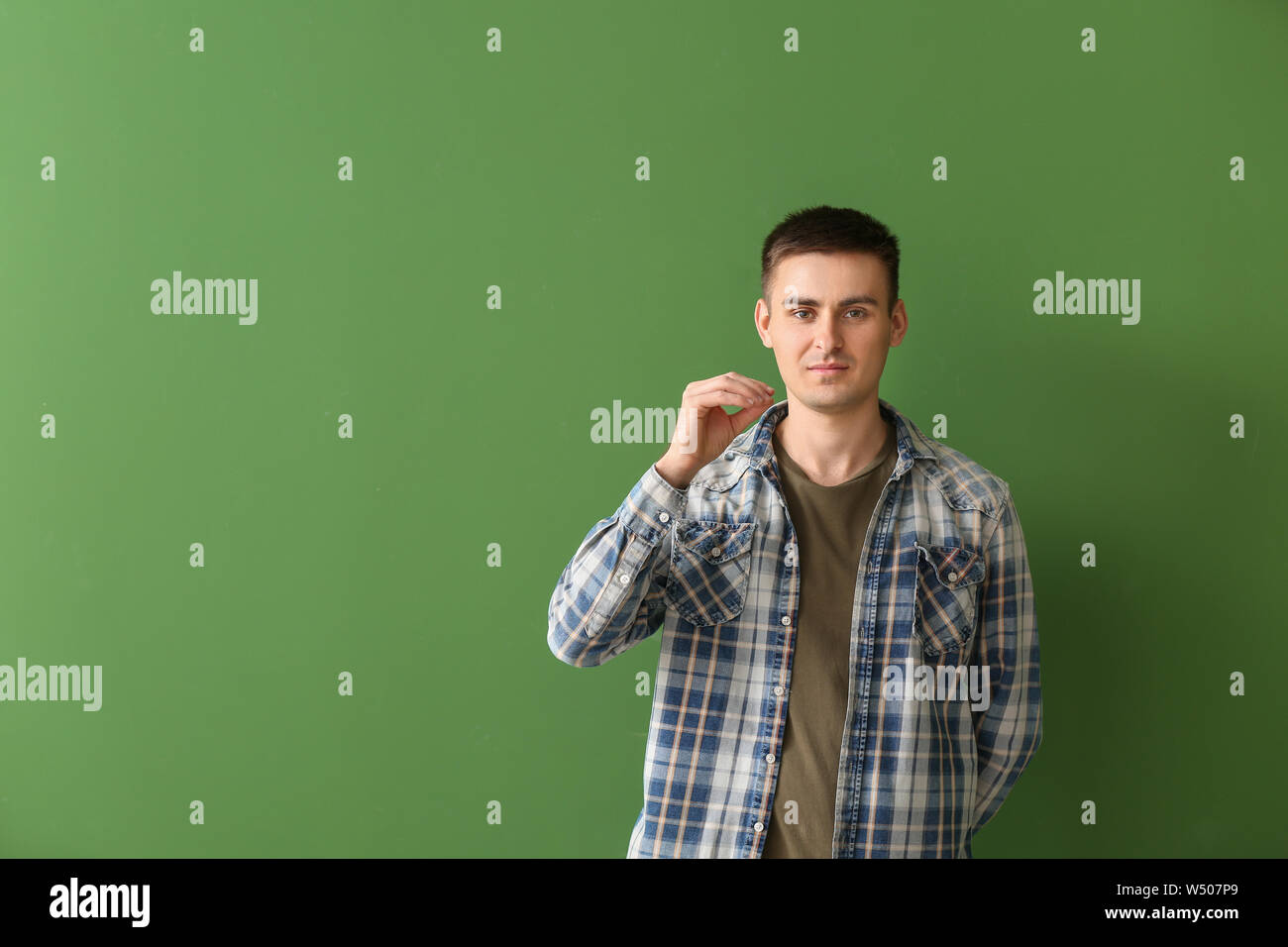 Young deaf mute man using sign language on color background Stock Photo ...