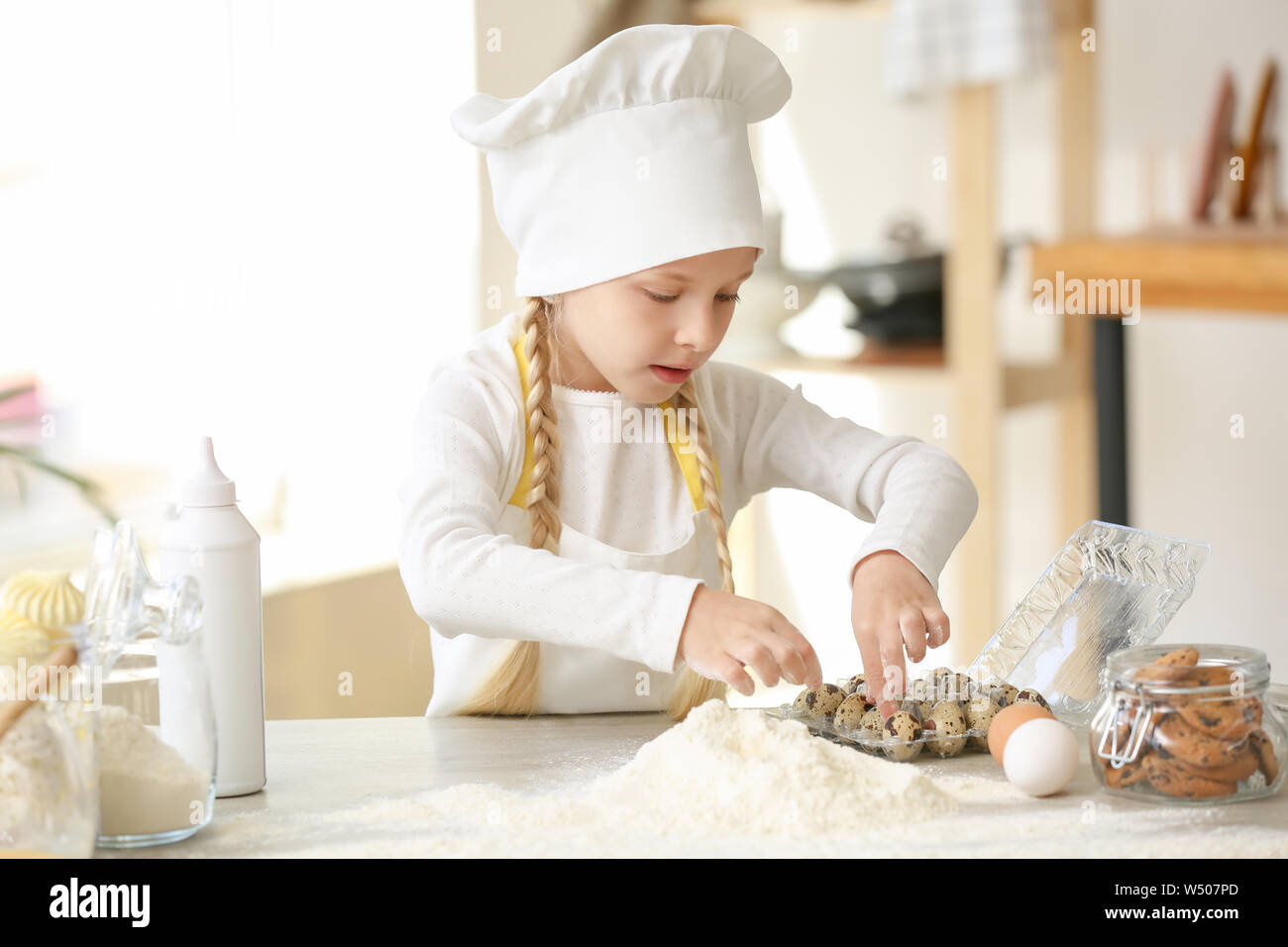 Cute little chef cooking in kitchen Stock Photo - Alamy