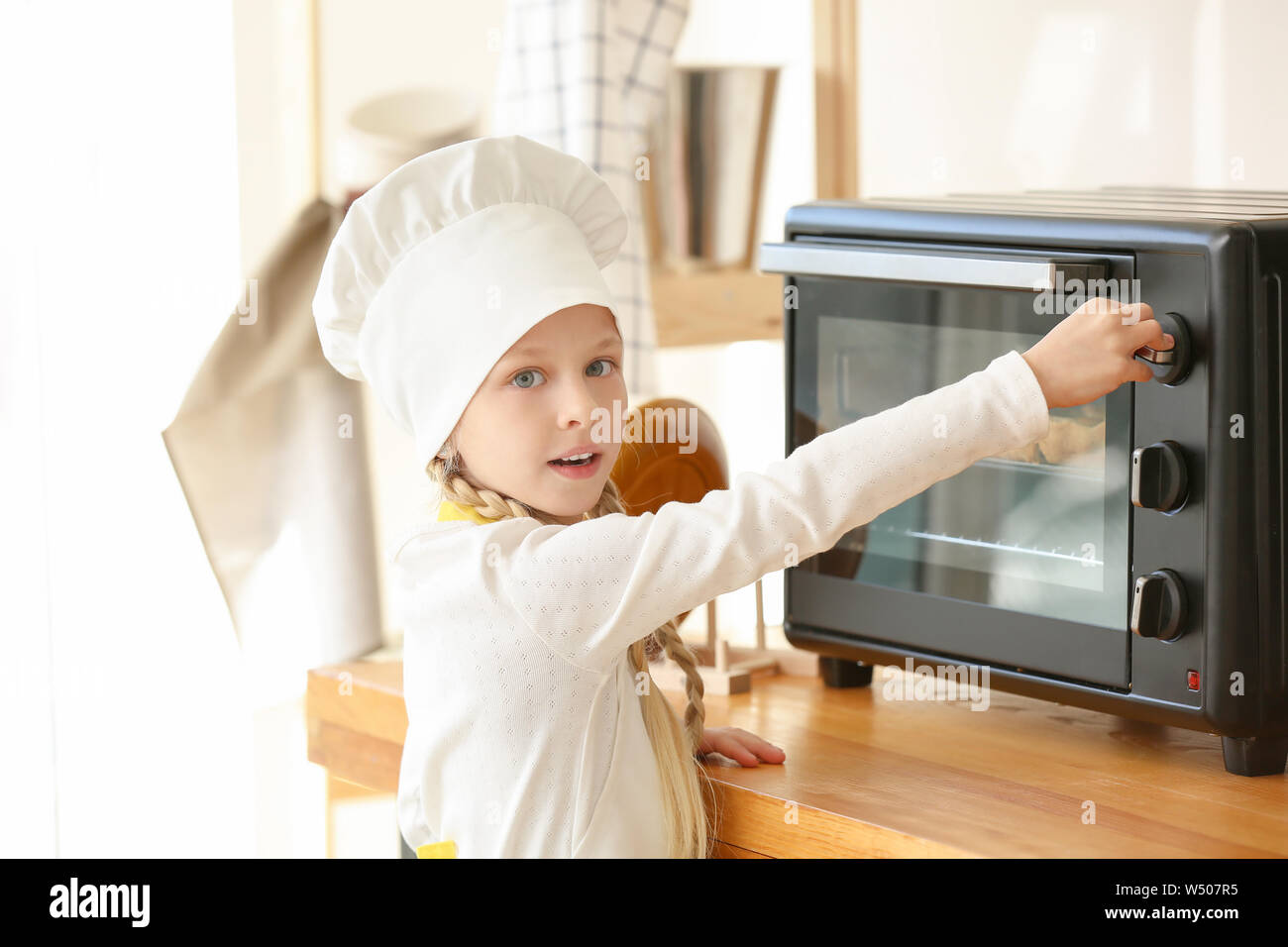 Cute little chef cooking in kitchen Stock Photo - Alamy