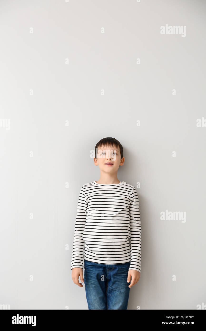 Cute little boy on light background Stock Photo - Alamy
