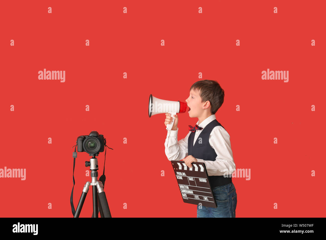 Little film director on color background Stock Photo - Alamy