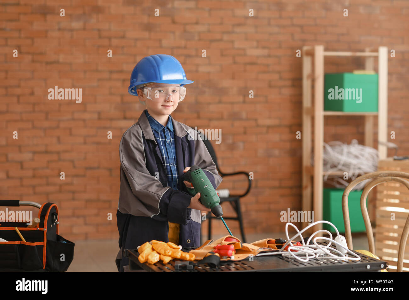 Cute little worker indoors Stock Photo - Alamy
