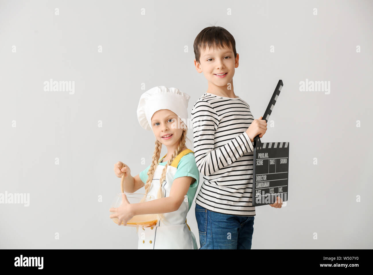 Little chef and film director on white background Stock Photo - Alamy