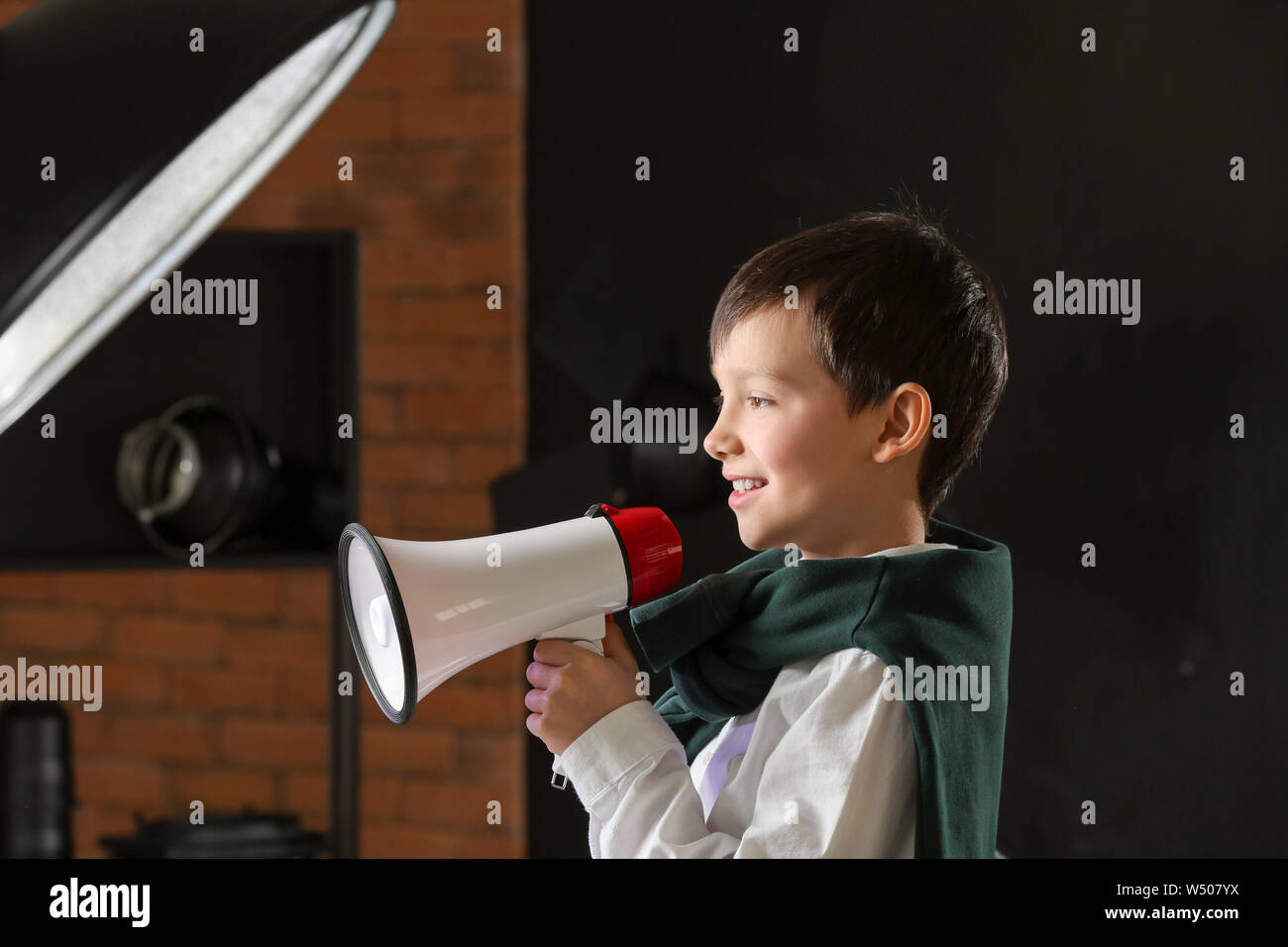 Little film director with megaphone in studio Stock Photo - Alamy