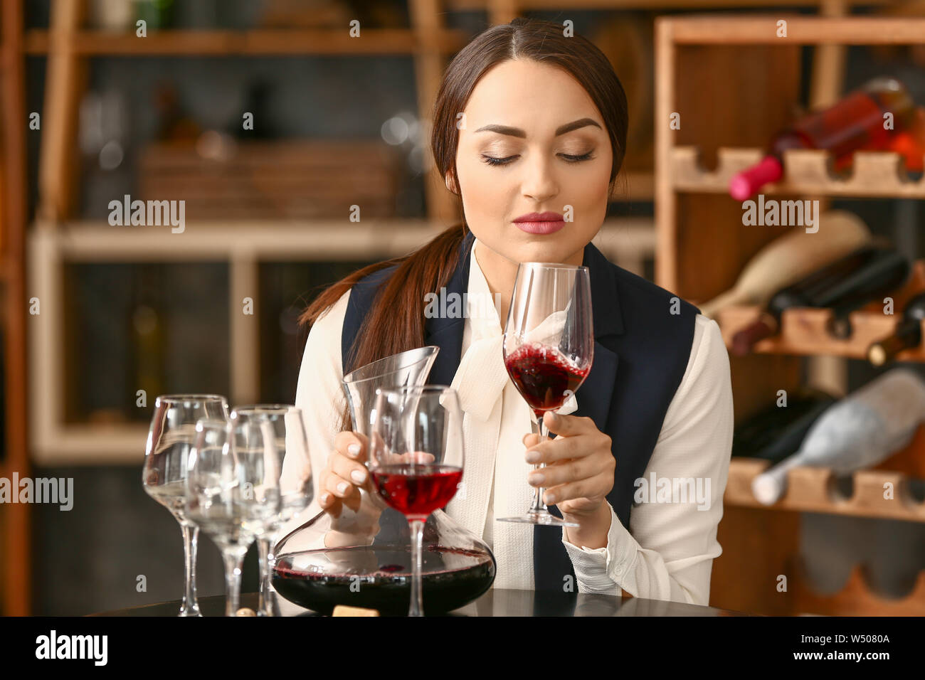 Female sommelier working in wine cellar Stock Photo - Alamy