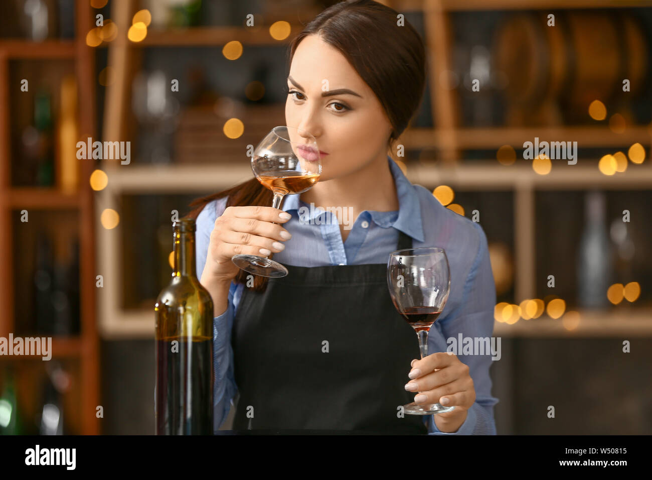 Female sommelier working in wine cellar Stock Photo - Alamy